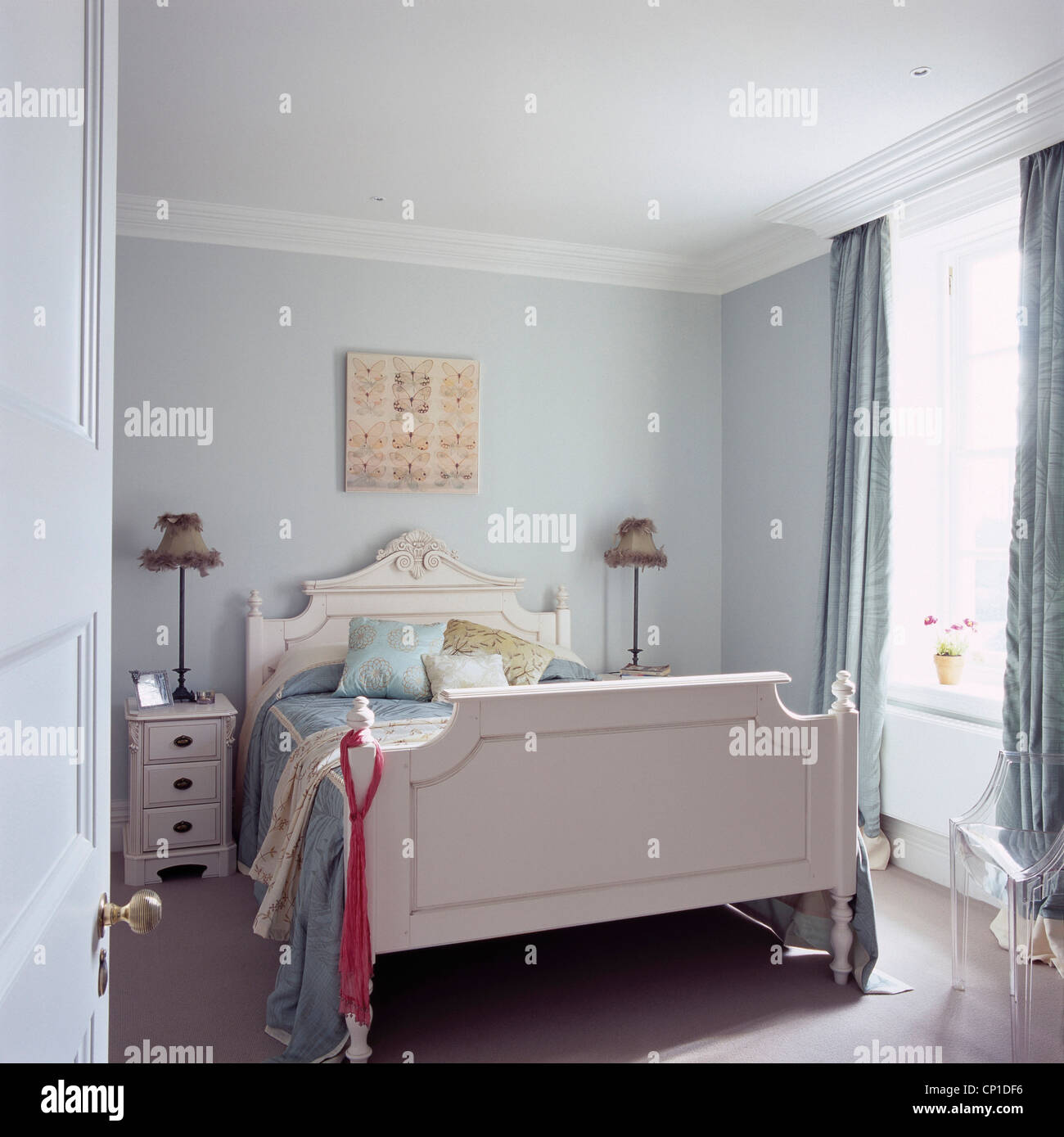 A traditional blue bedroom, period style wooden double bed with two ...