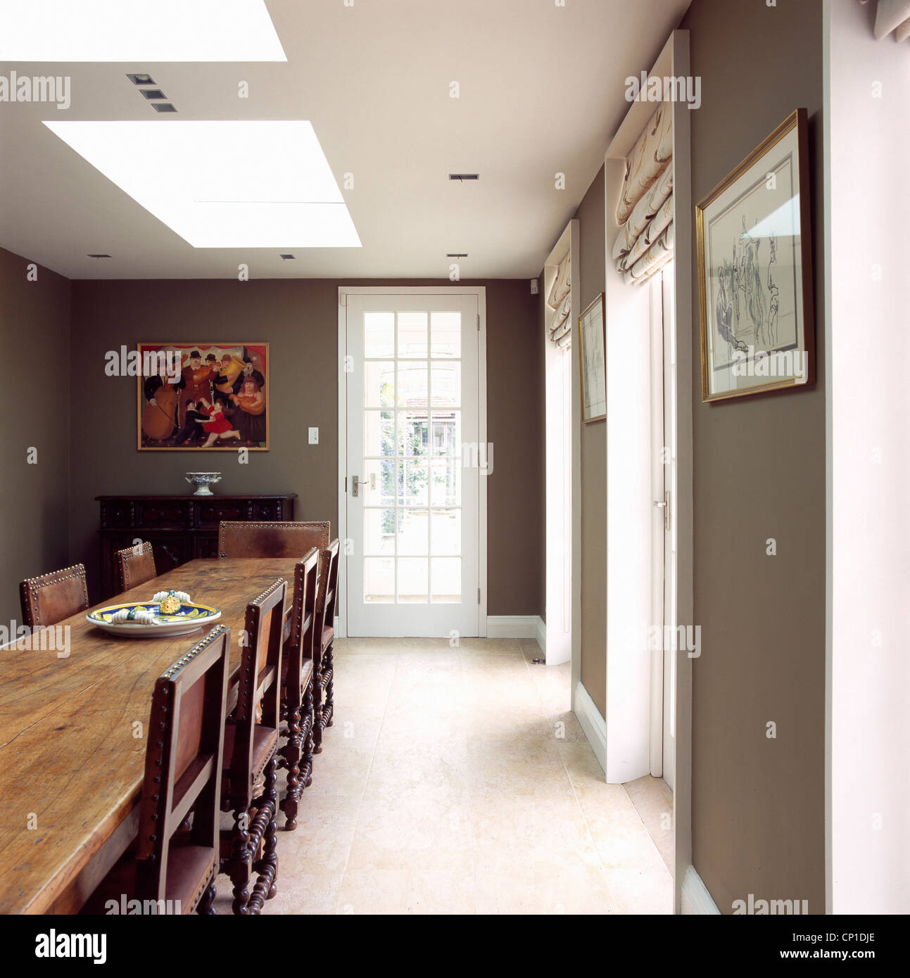 Dining room with long table and chairs Stock Photo - Alamy