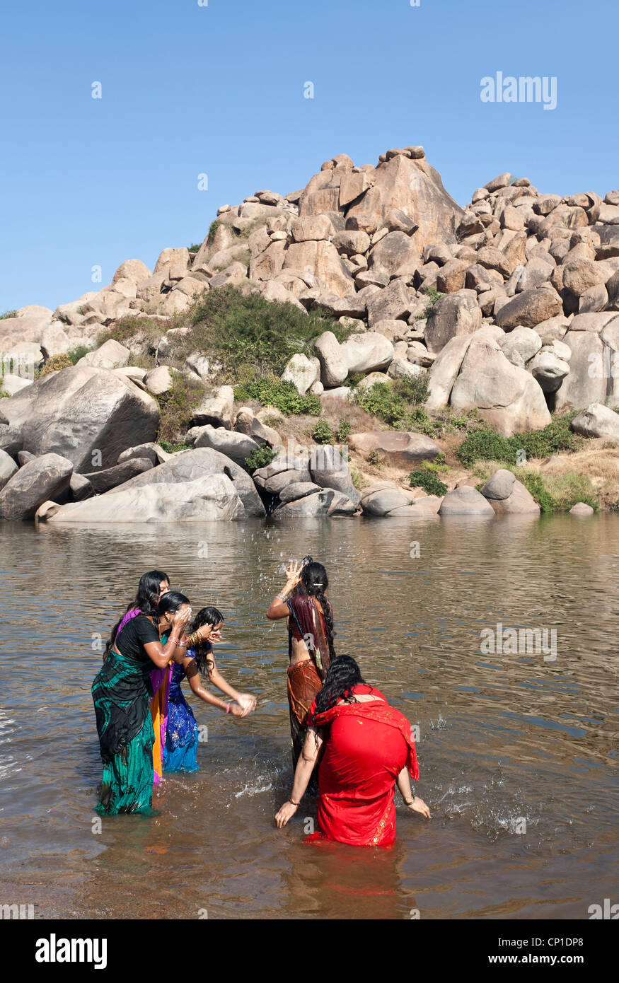 Women bathing in the Tungabhadra river. Hampi. India Stock Photo - Alamy