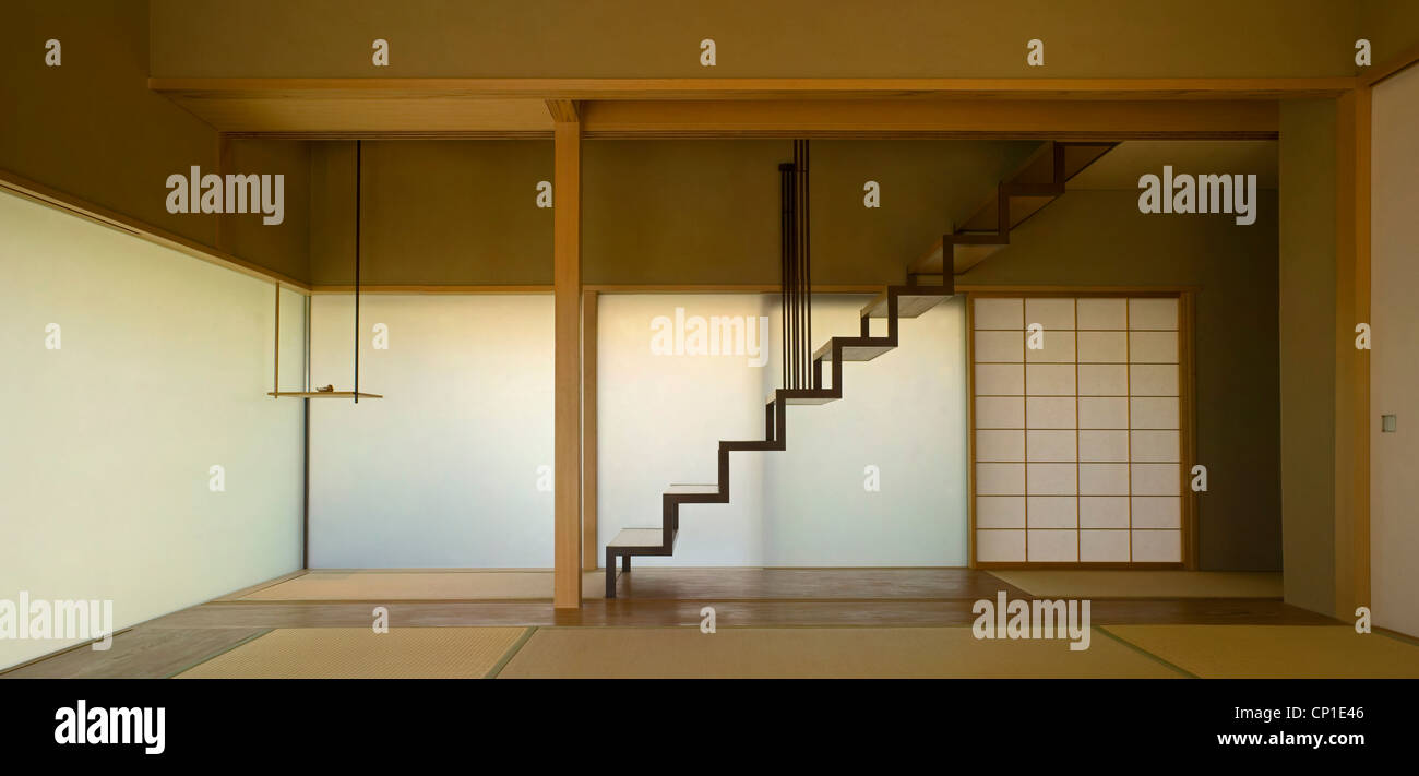 Traditionally Japanese sparsely furnished room with staircase Stock ...