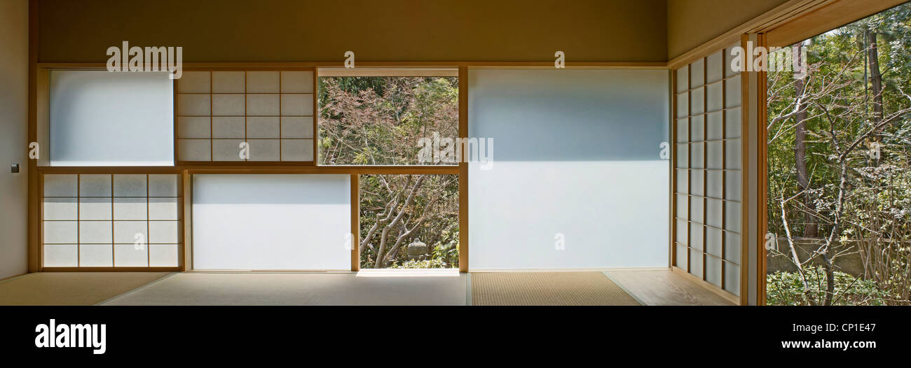 Traditionally Japanese sparsely furnished room with view through ...