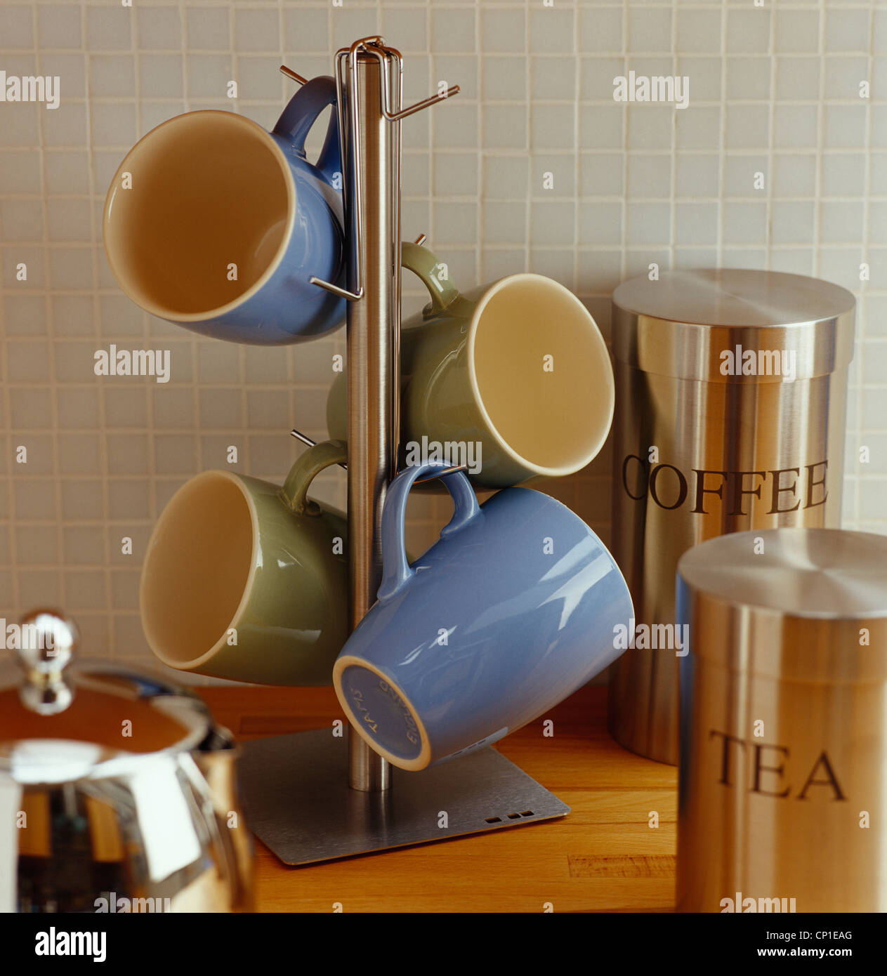 Chrome mug tree next to storage containers Stock Photo - Alamy
