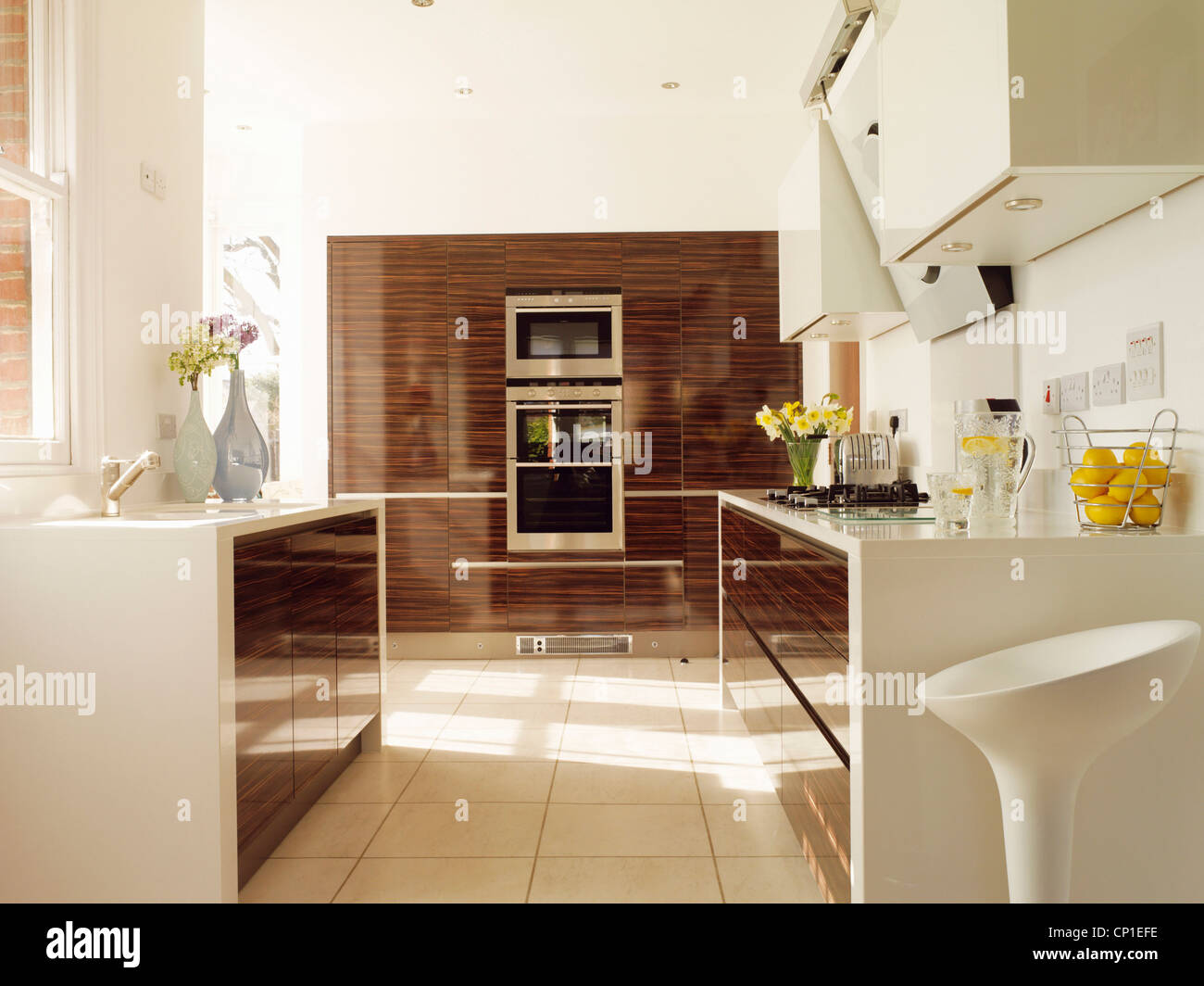 Integral oven set in wooden unit in spacious contemporary kitchen Stock ...