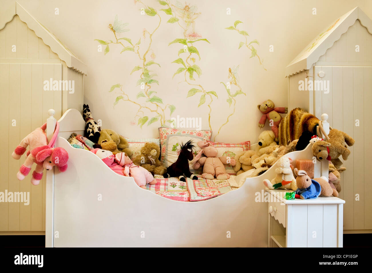 Soft toys on bed in childs bedroom Stock Photo - Alamy