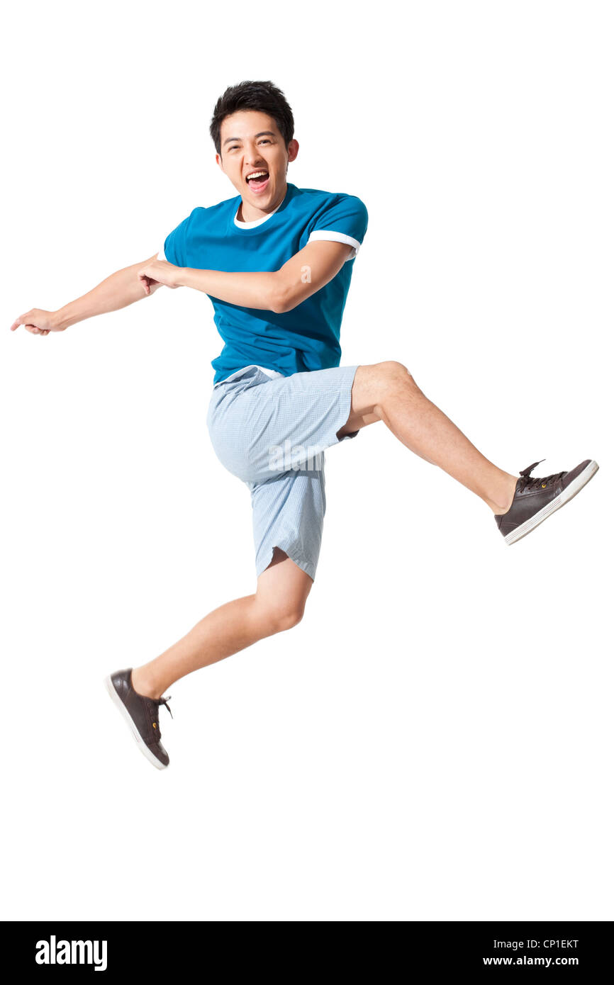 Young man jumping in mid-air Stock Photo - Alamy