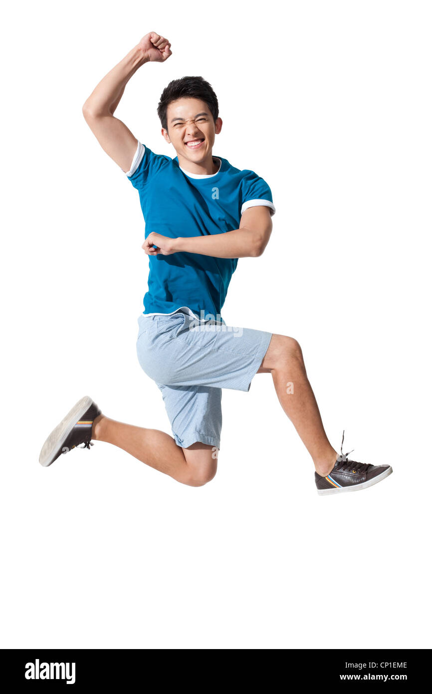 Young man jumping in mid-air Stock Photo - Alamy