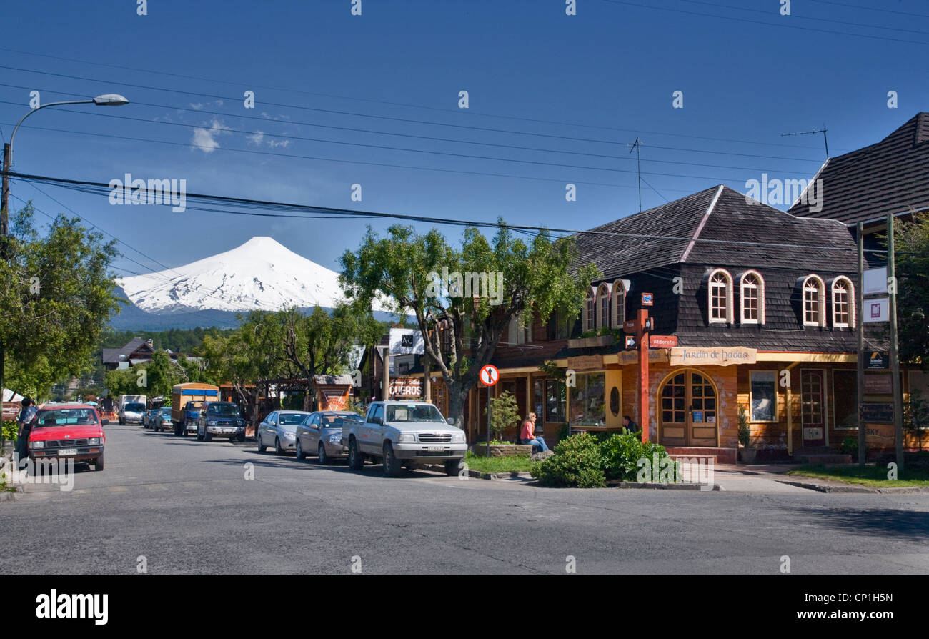 Volcano VIllarrica dominates a street view of downtown Pucon, Chile ...