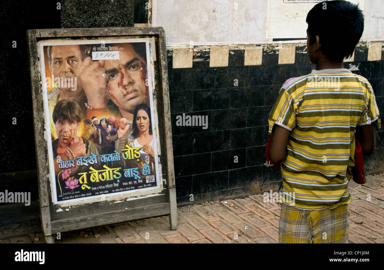Boy watching the poster in front of cinema in Kolkata Stock Photo - Alamy