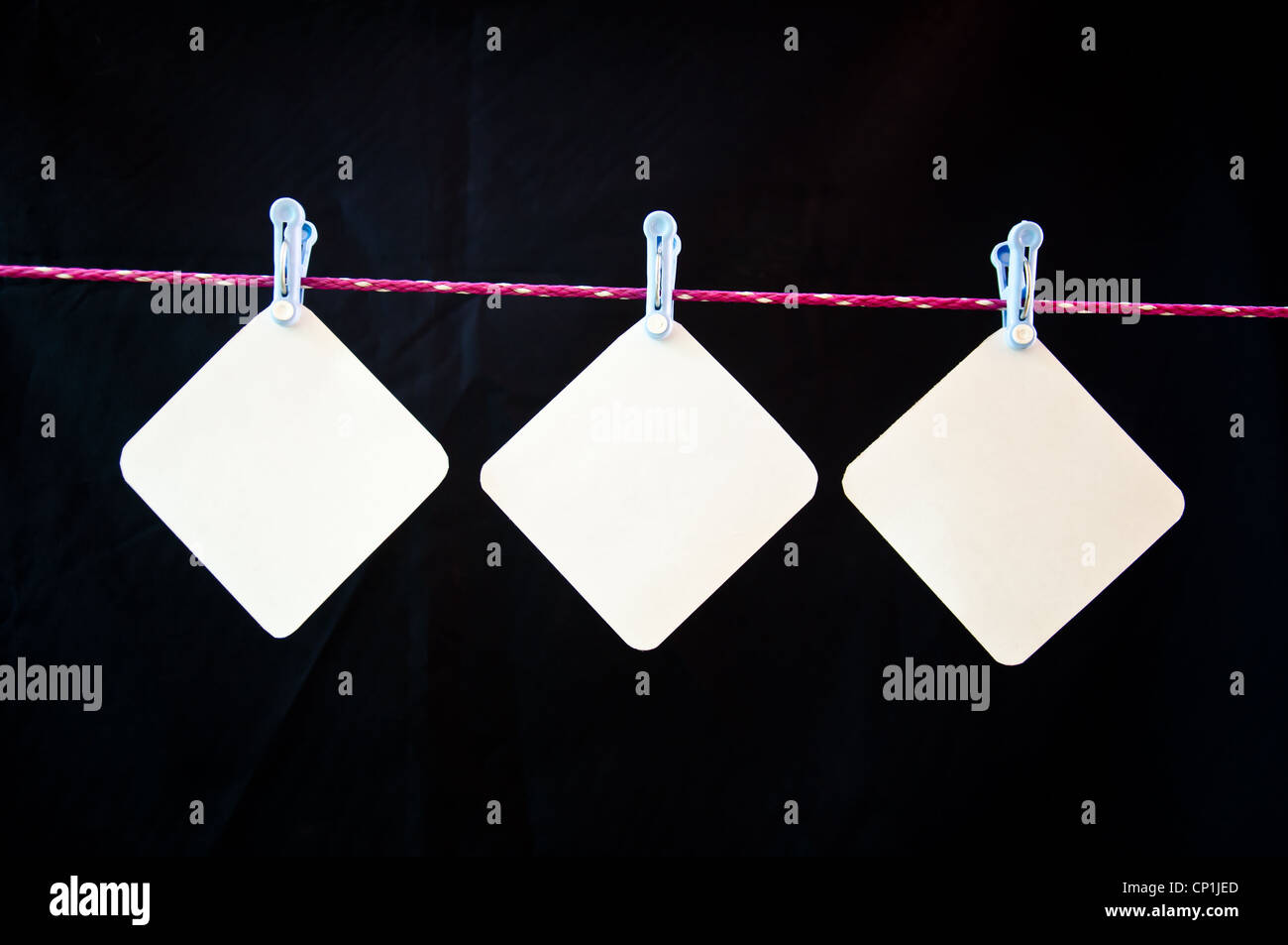 hang paper on black background Stock Photo - Alamy
