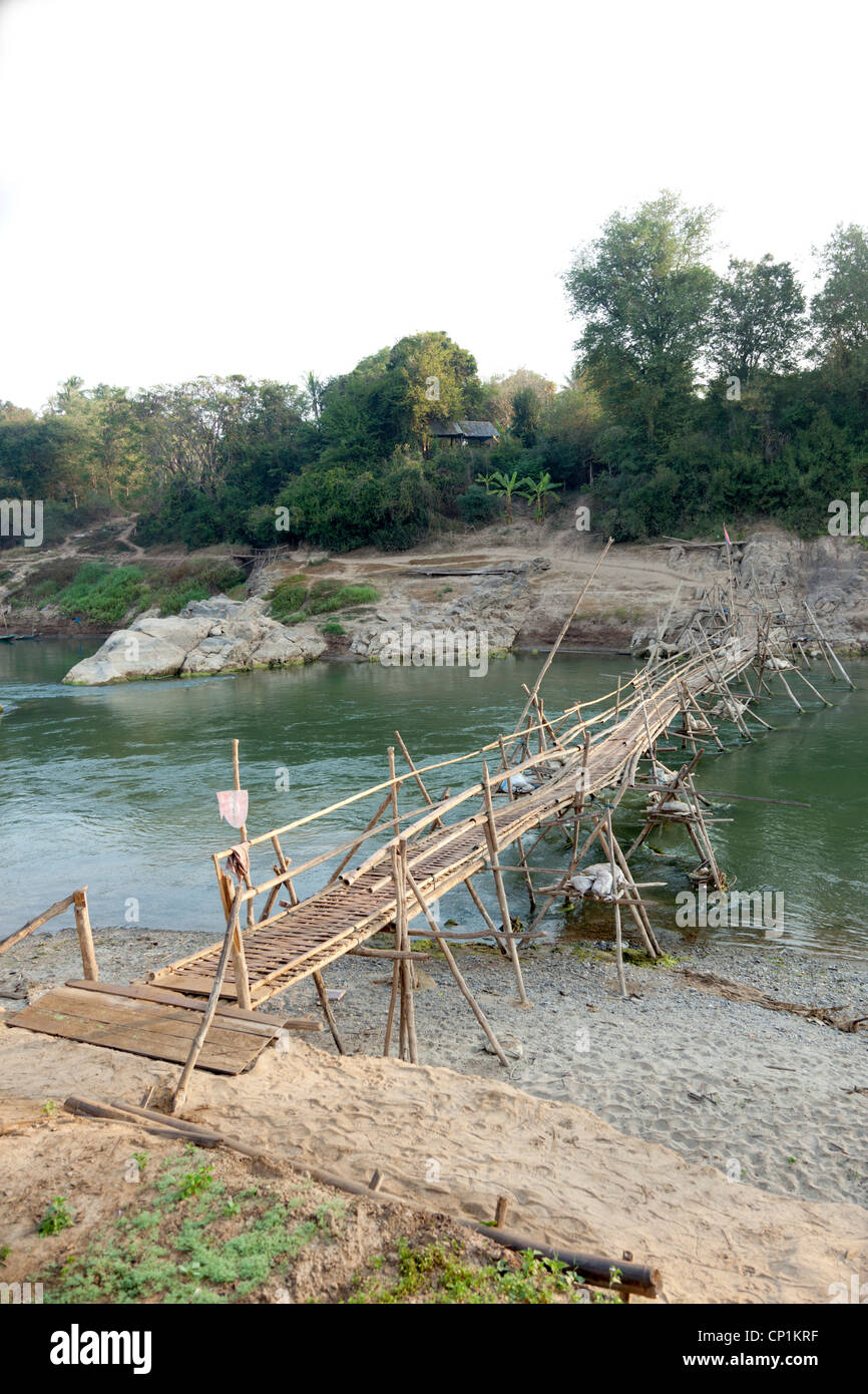 A flimsy bamboo footbridge thrown across the Khan river, a tributary of ...