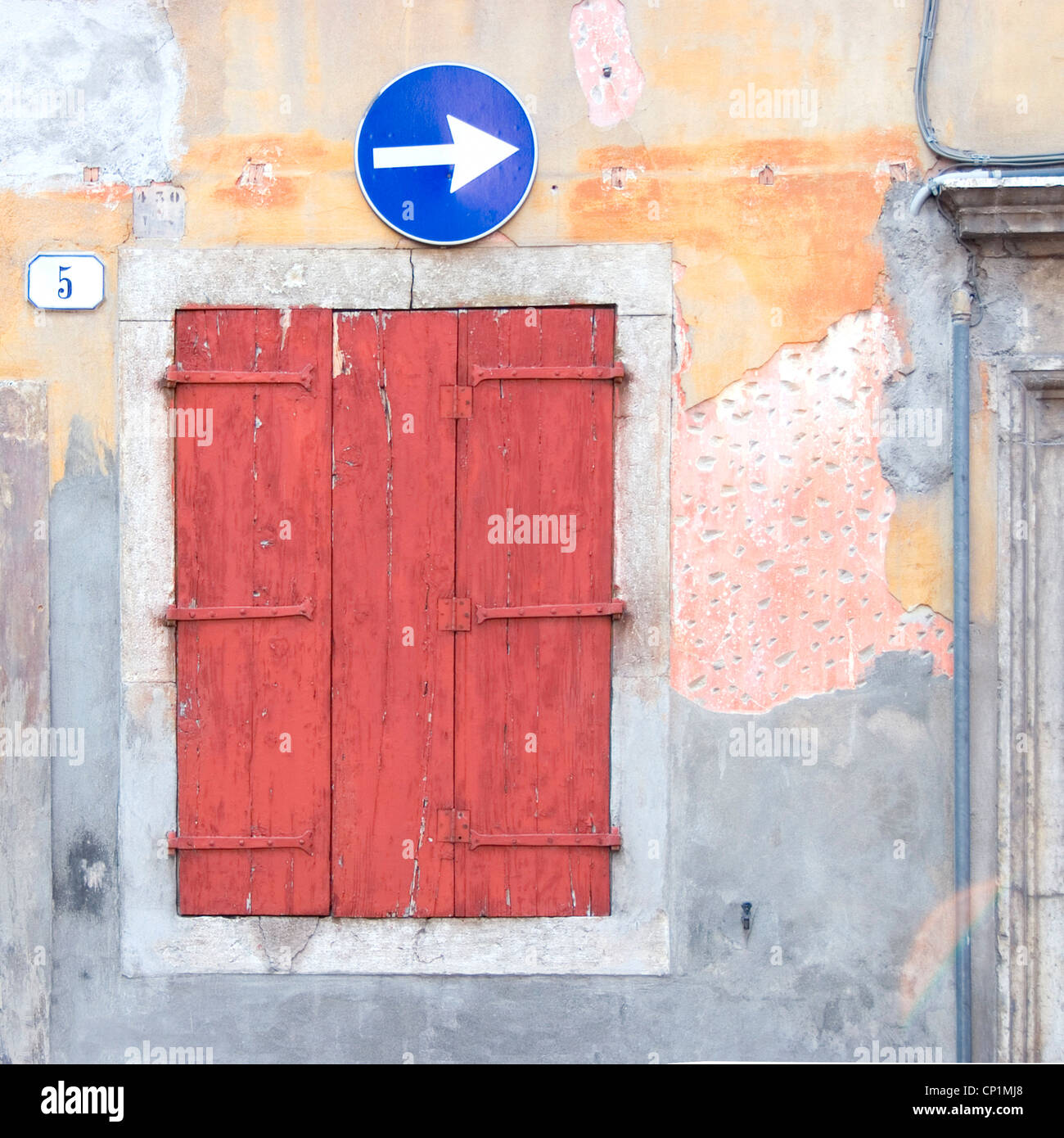 One way traffic sign above shuttered window in Venice, Italy Stock ...