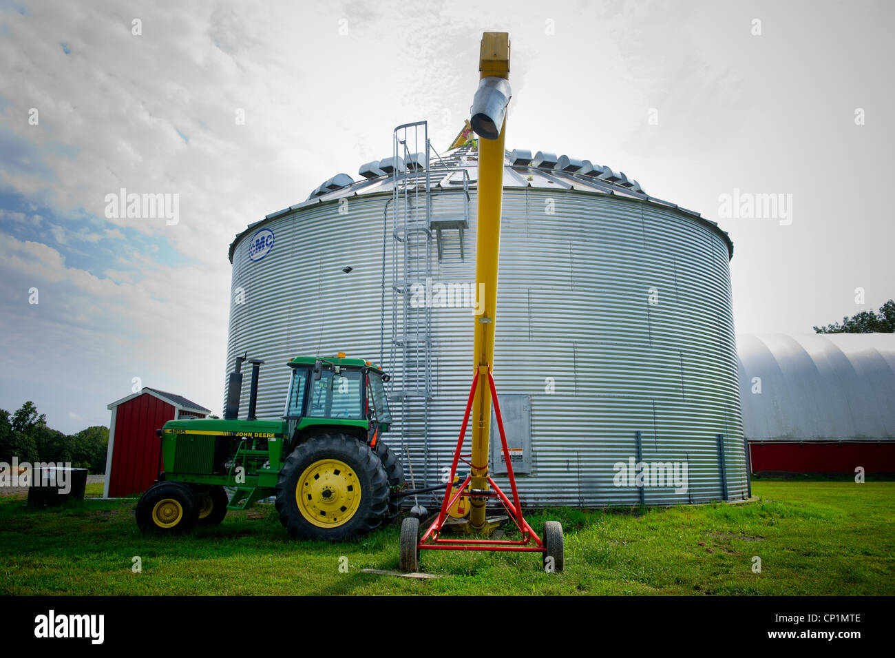 Grain bin and tractor on a farm Stock Photo - Alamy