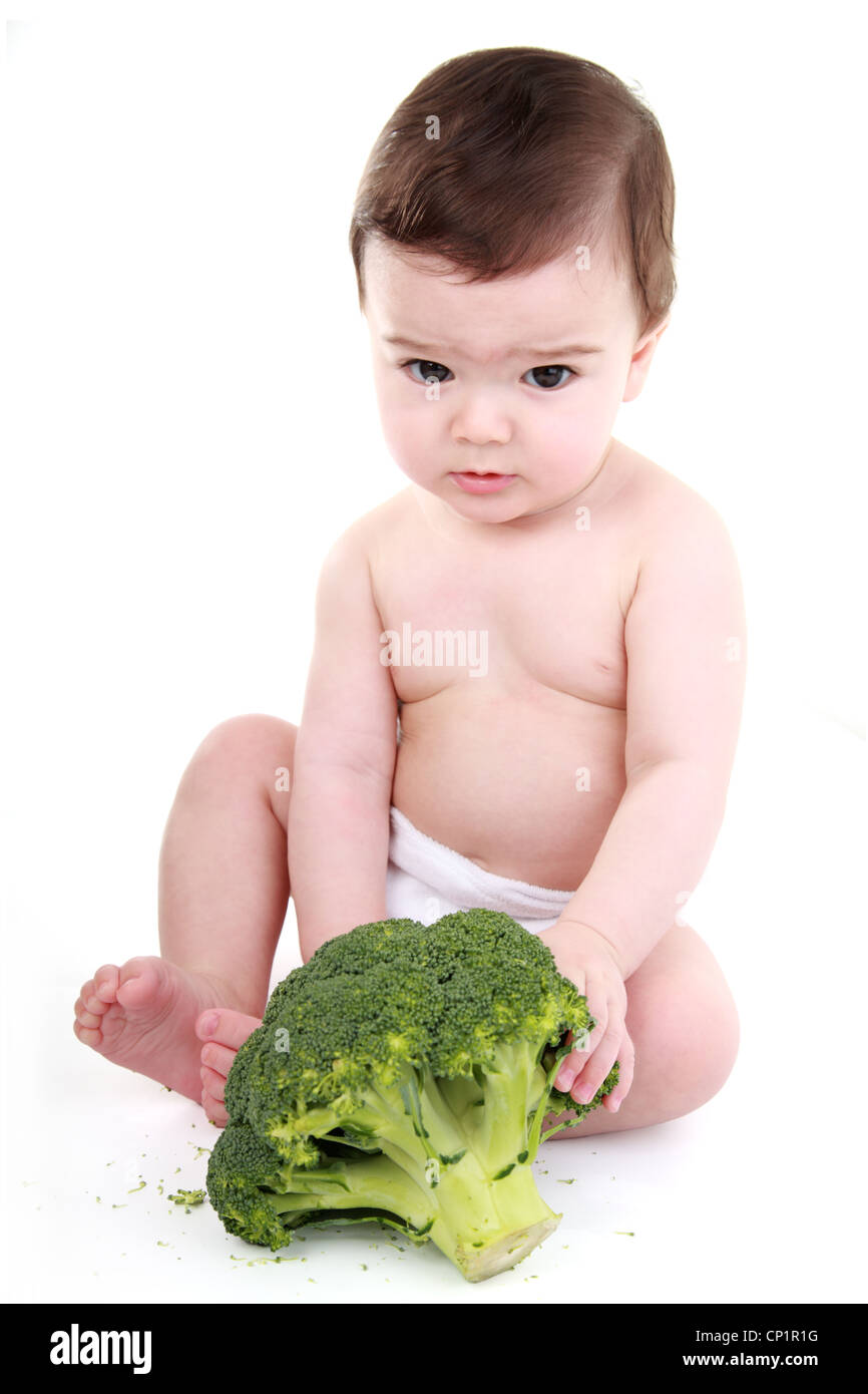Baby sitting with broccoli Stock Photo - Alamy