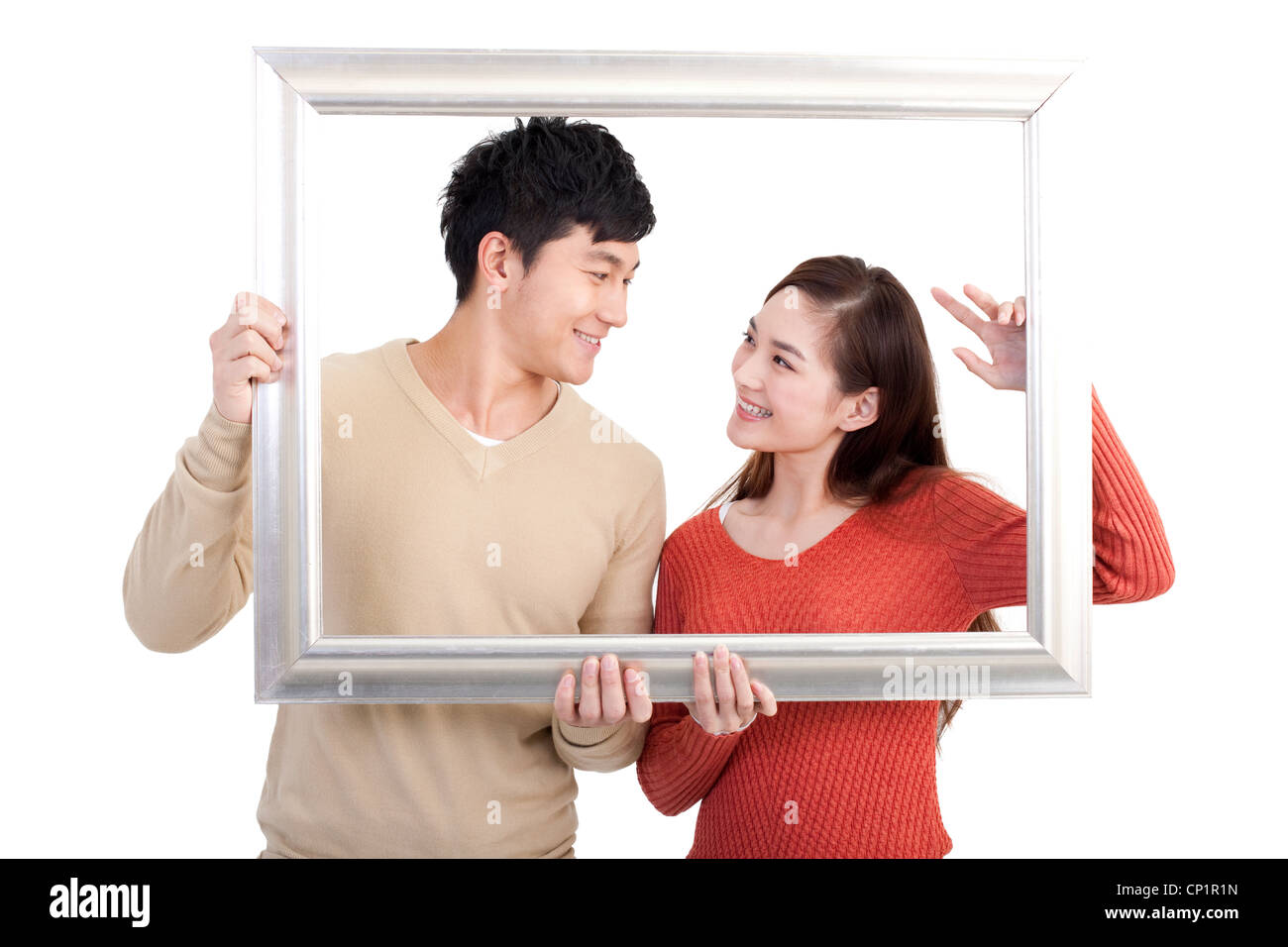 Happy young couple and picture frame Stock Photo - Alamy