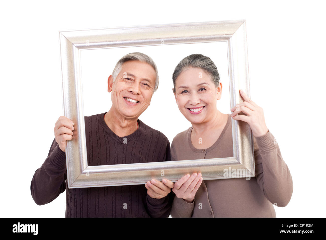 Happy senior couple and picture frame Stock Photo - Alamy
