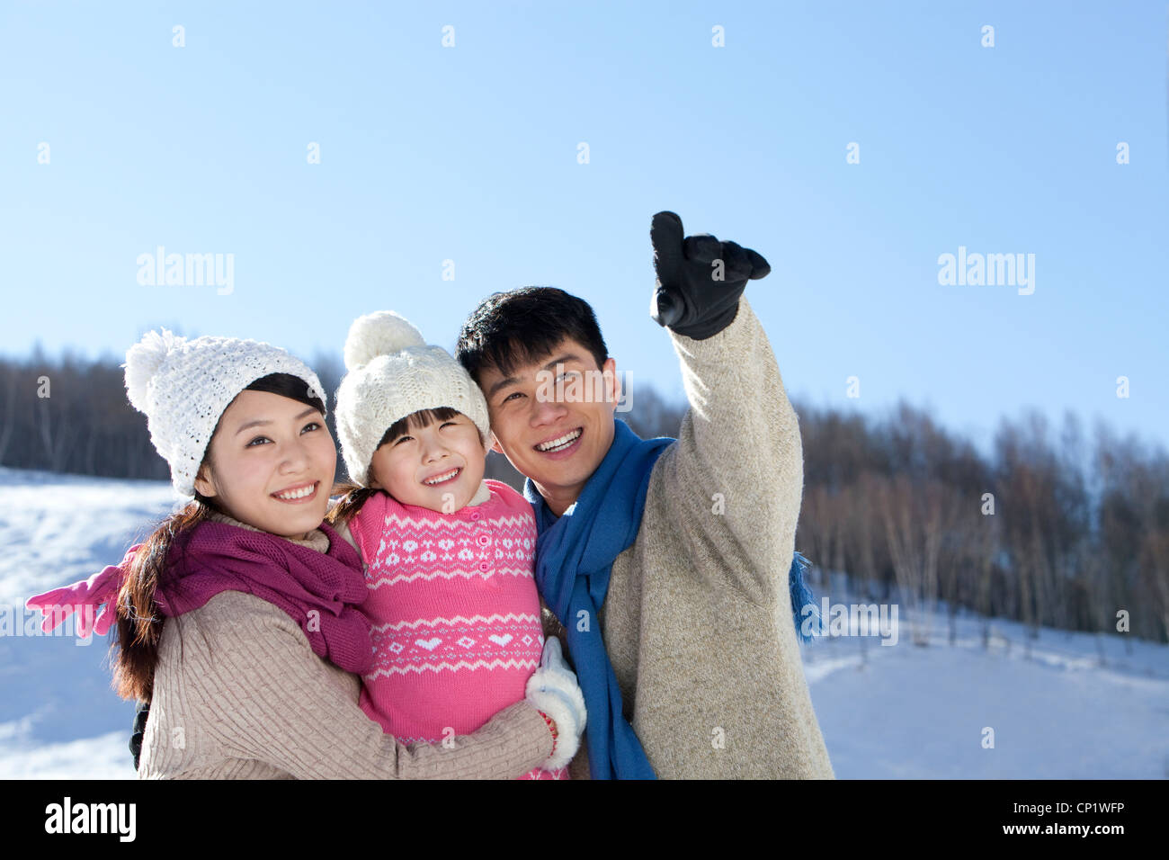 Family looking afar in winter time Stock Photo - Alamy