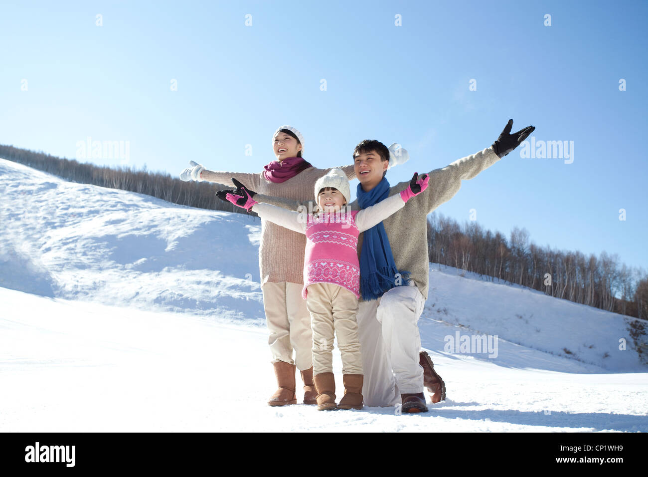 Family having fun in snow Stock Photo - Alamy