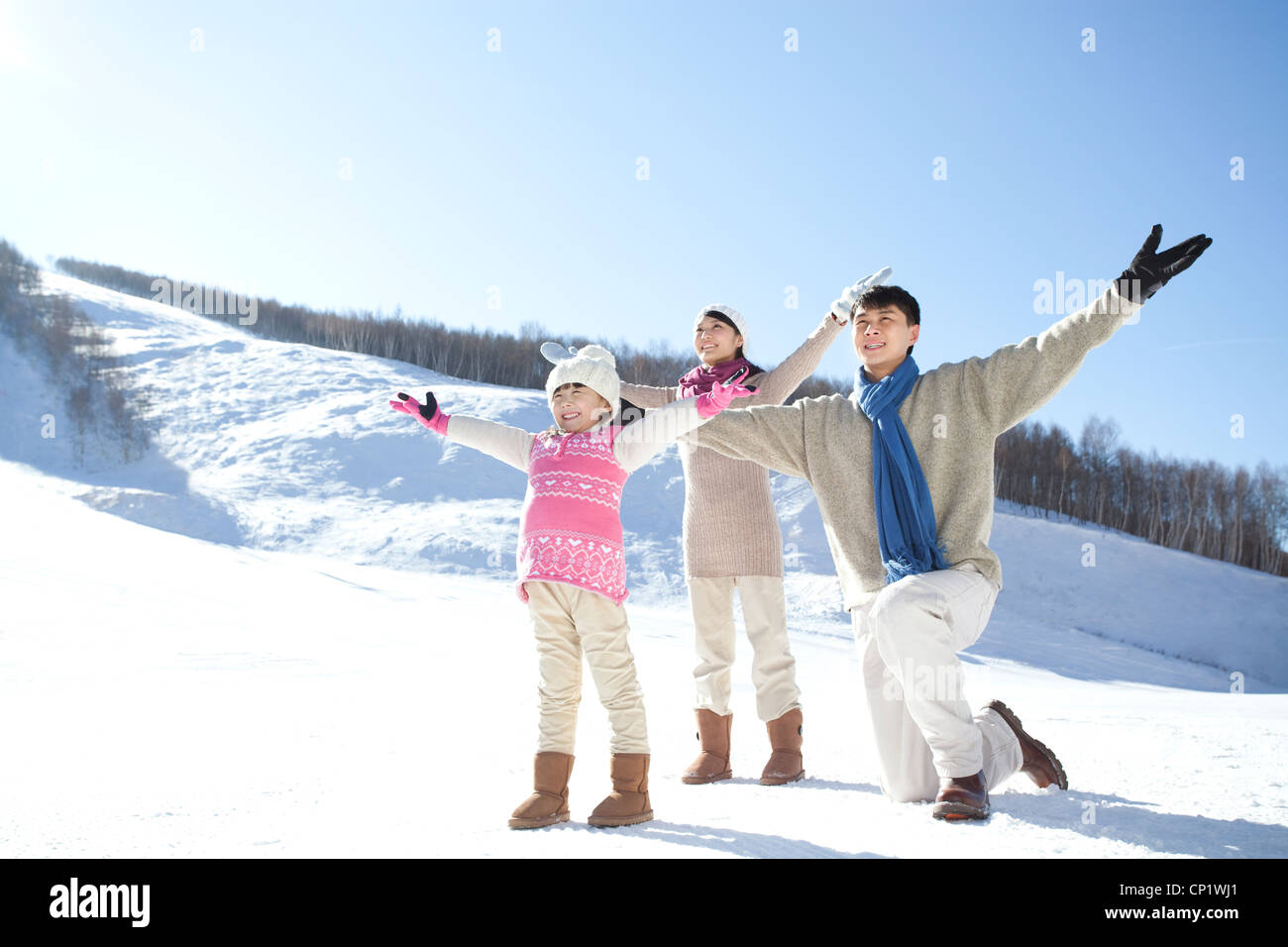 Family having fun in snow Stock Photo - Alamy