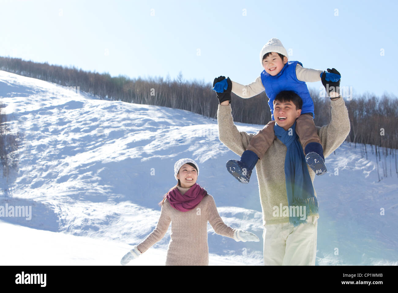 Family having fun in snow Stock Photo - Alamy
