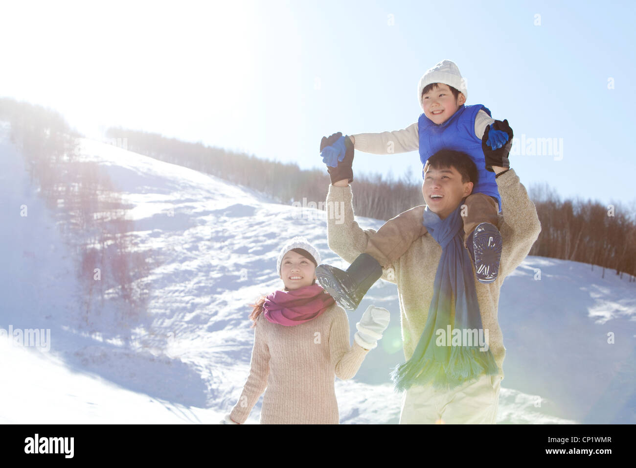 Family having fun in snow Stock Photo - Alamy