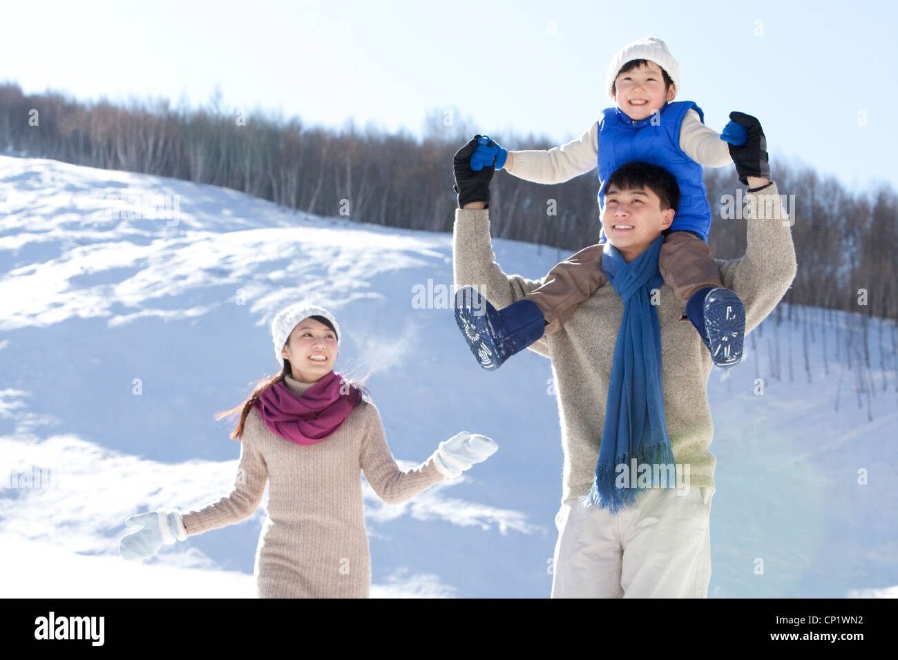 Family having fun in snow Stock Photo - Alamy