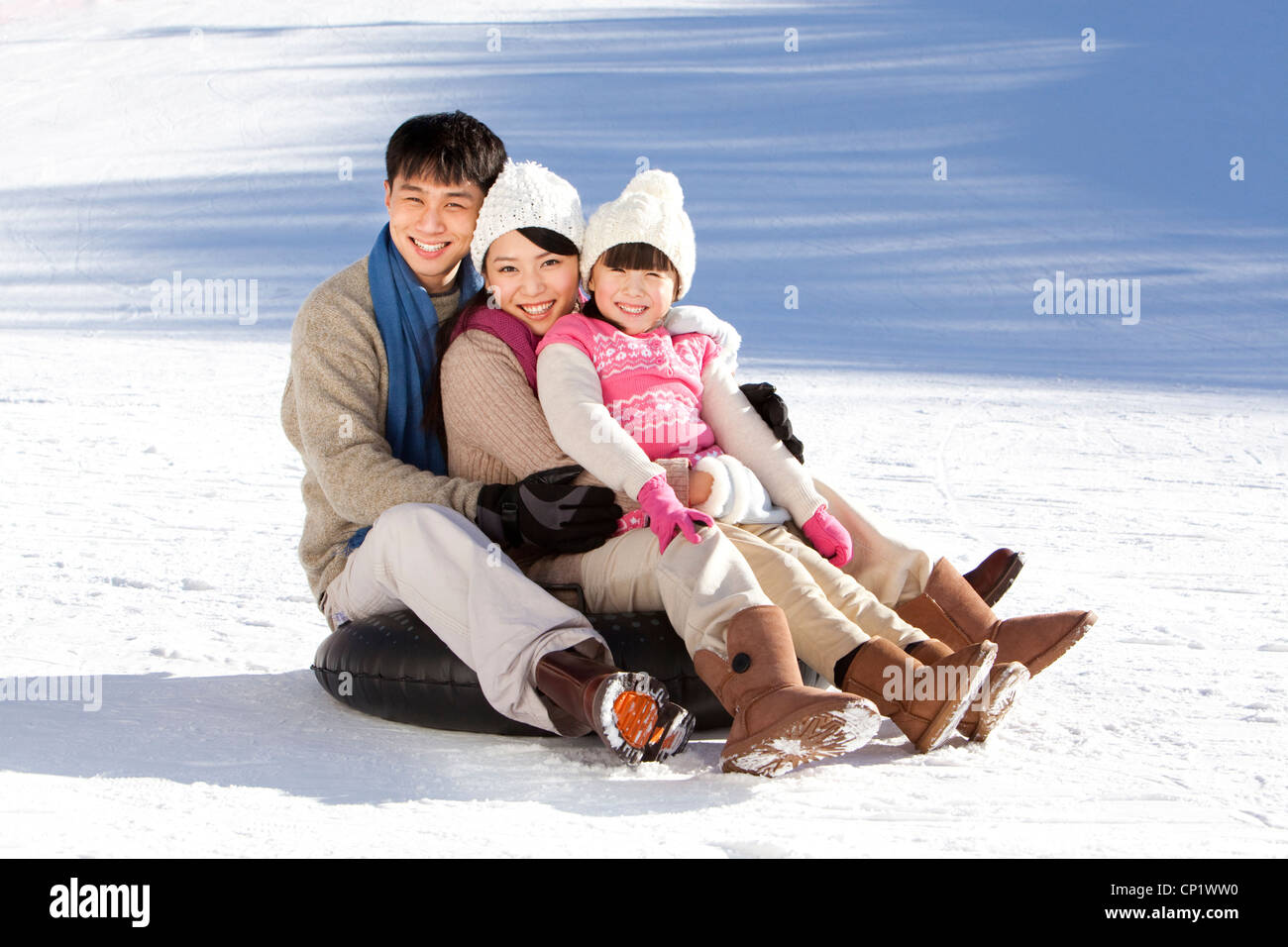Family having fun in snow Stock Photo - Alamy