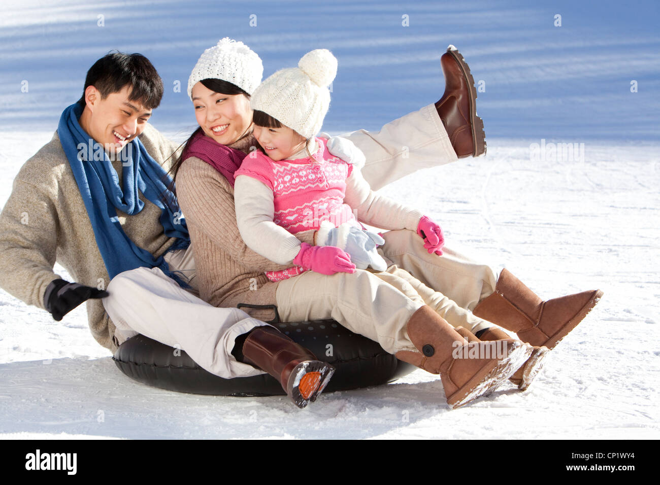 Family having fun in snow Stock Photo - Alamy