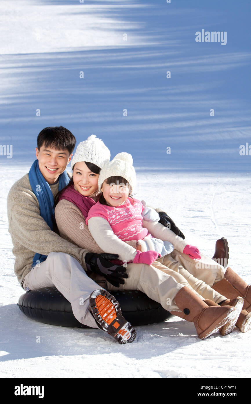 Family having fun in snow Stock Photo - Alamy