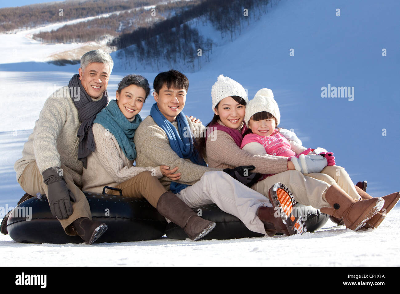 Family having fun in snow Stock Photo - Alamy