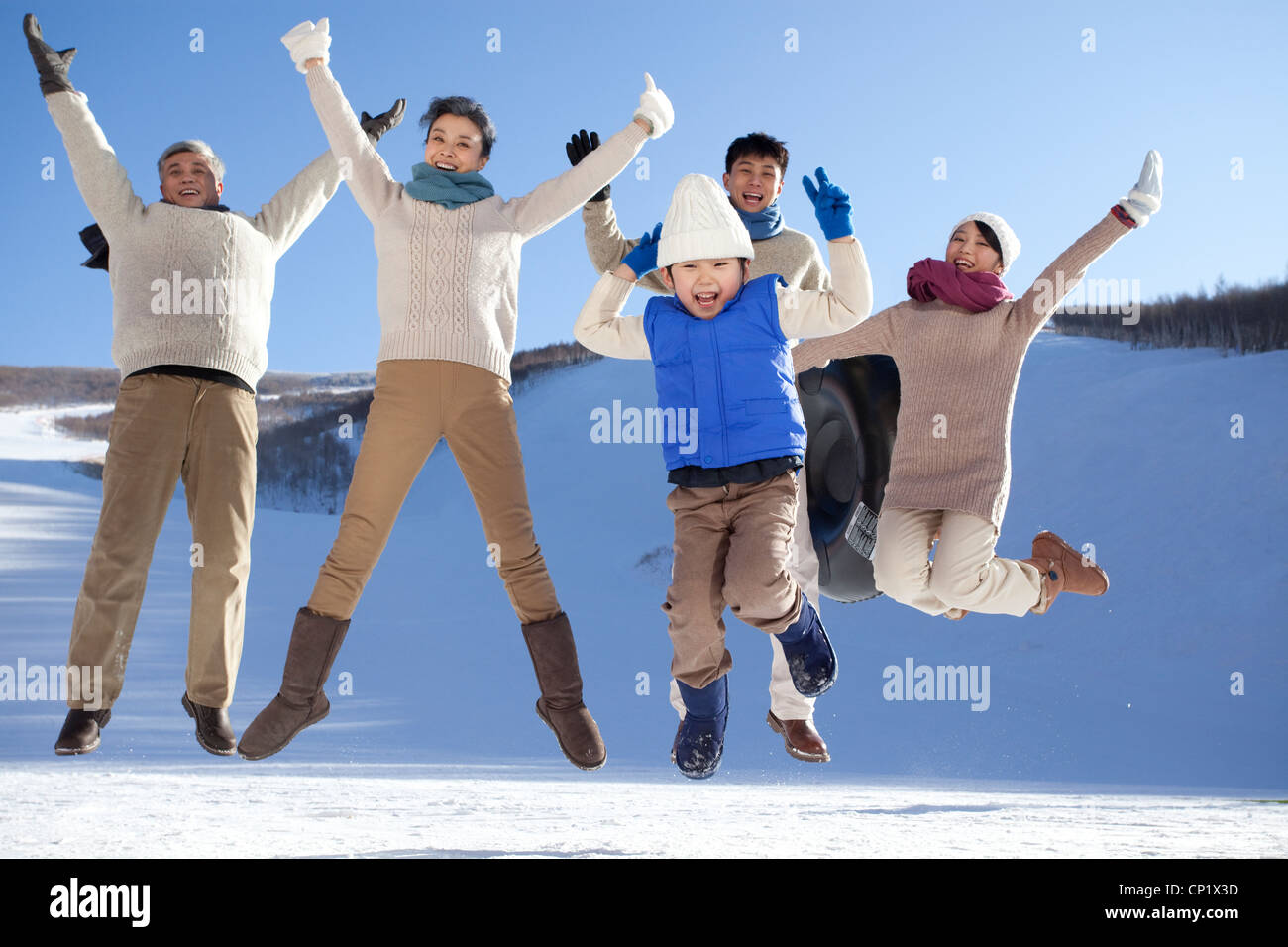 Family having fun in snow Stock Photo - Alamy