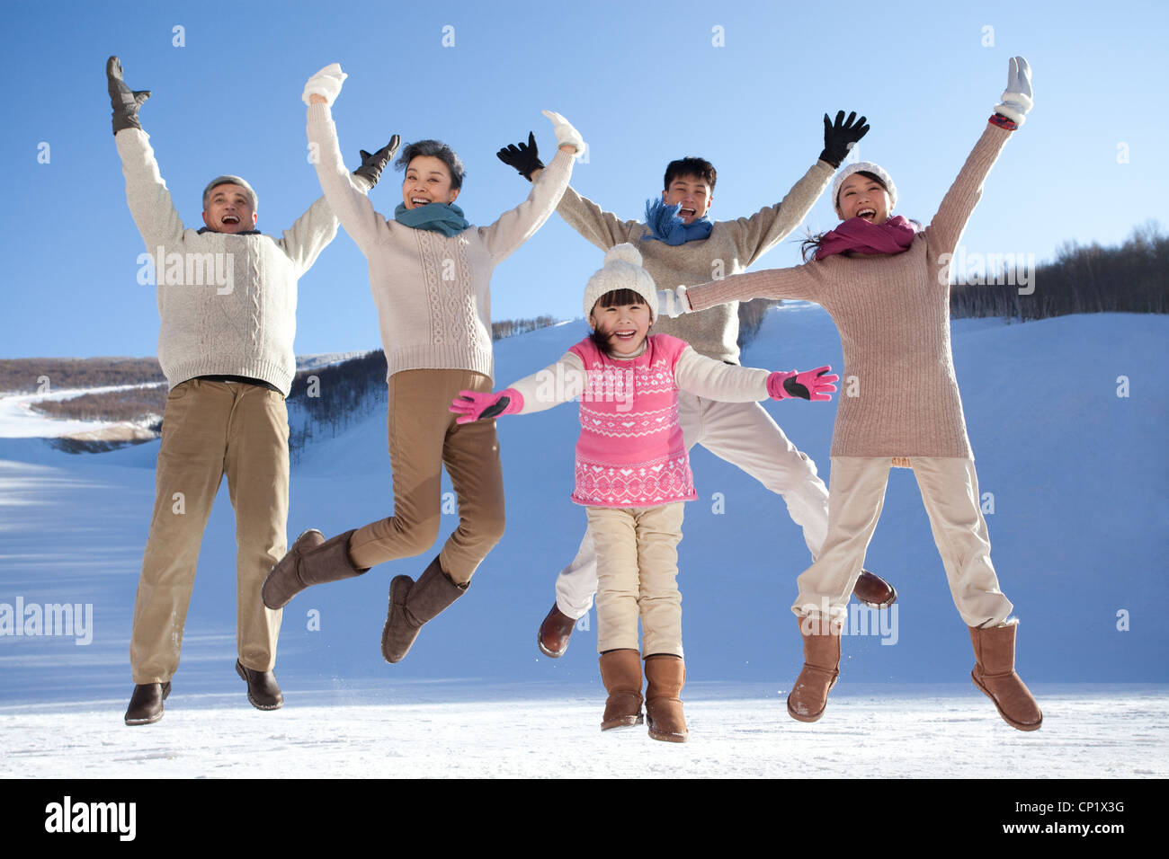 Family having fun in snow Stock Photo - Alamy