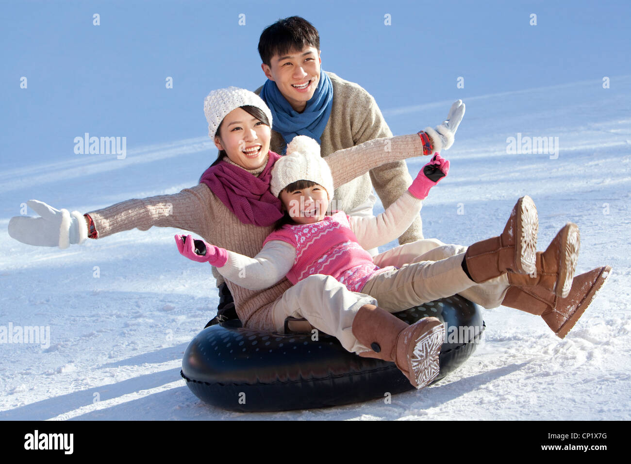 Family having fun in snow Stock Photo - Alamy