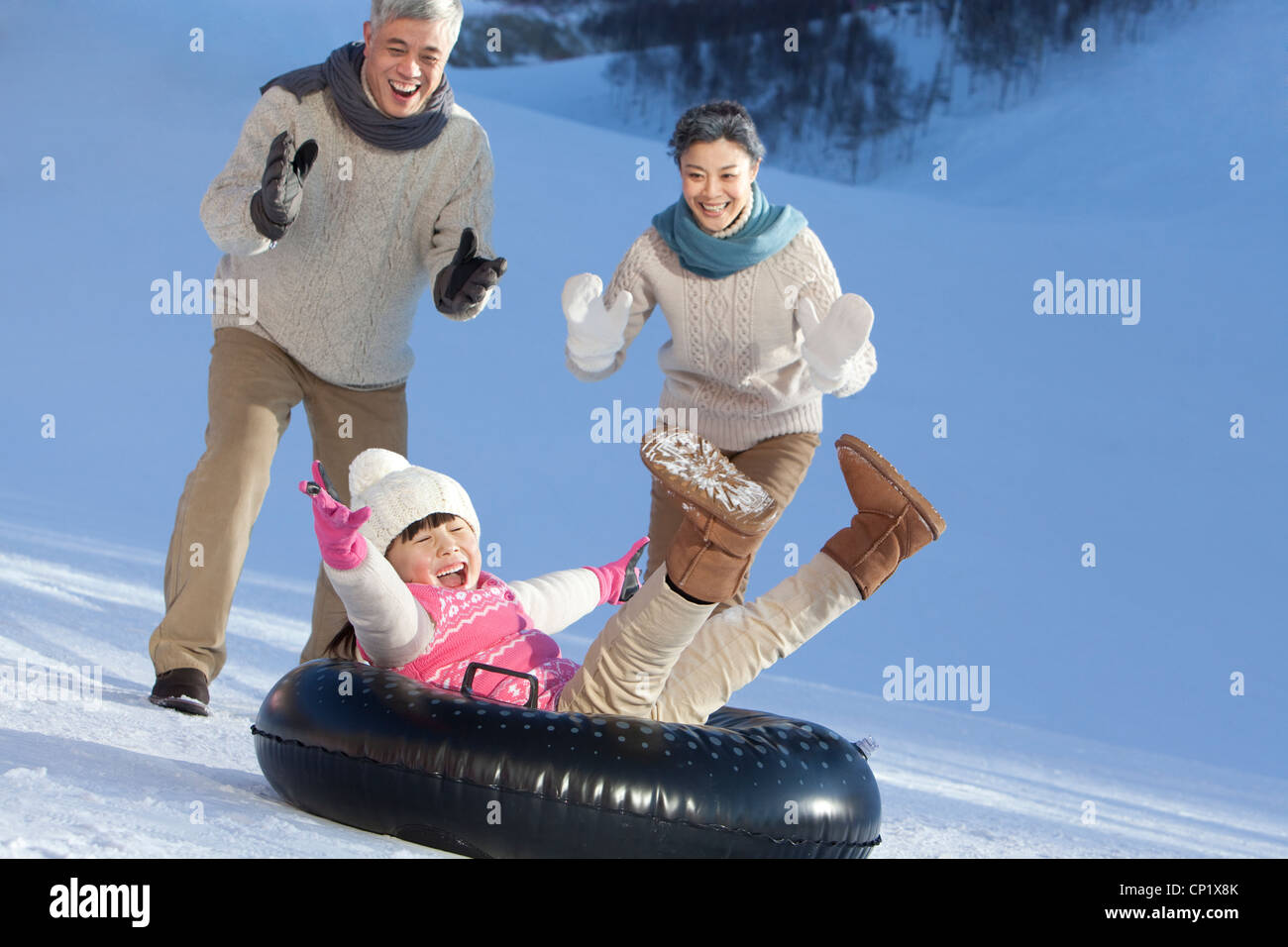 Family having fun in snow Stock Photo - Alamy