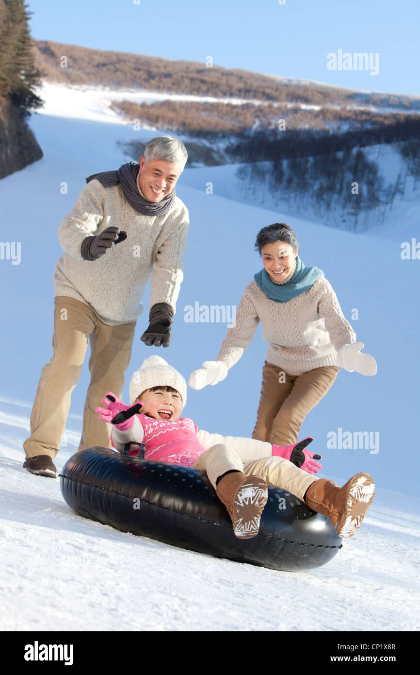 Family having fun in snow Stock Photo - Alamy