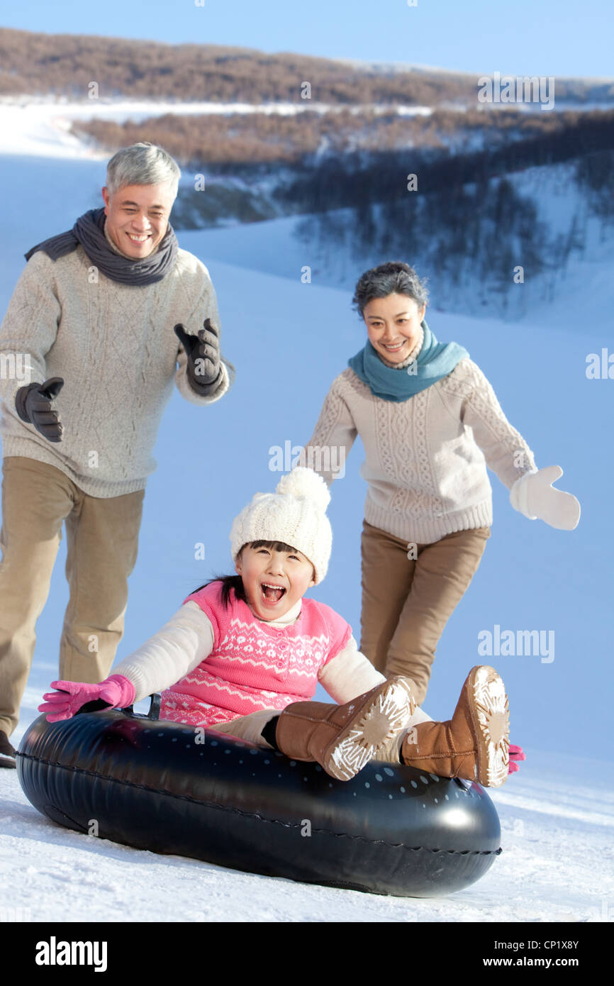 Family having fun in snow Stock Photo - Alamy