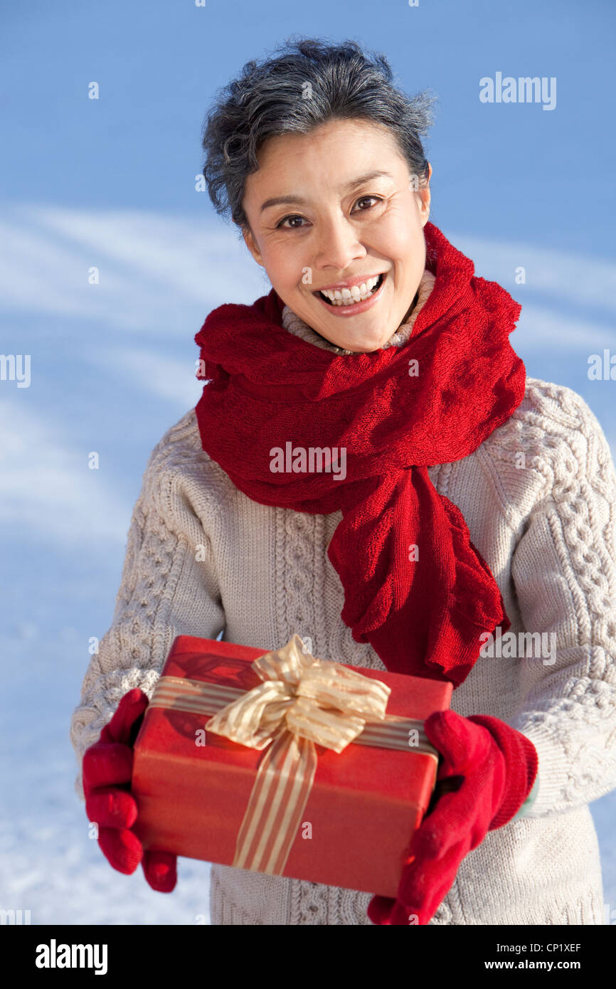 Senior woman holding gift boxes Stock Photo - Alamy