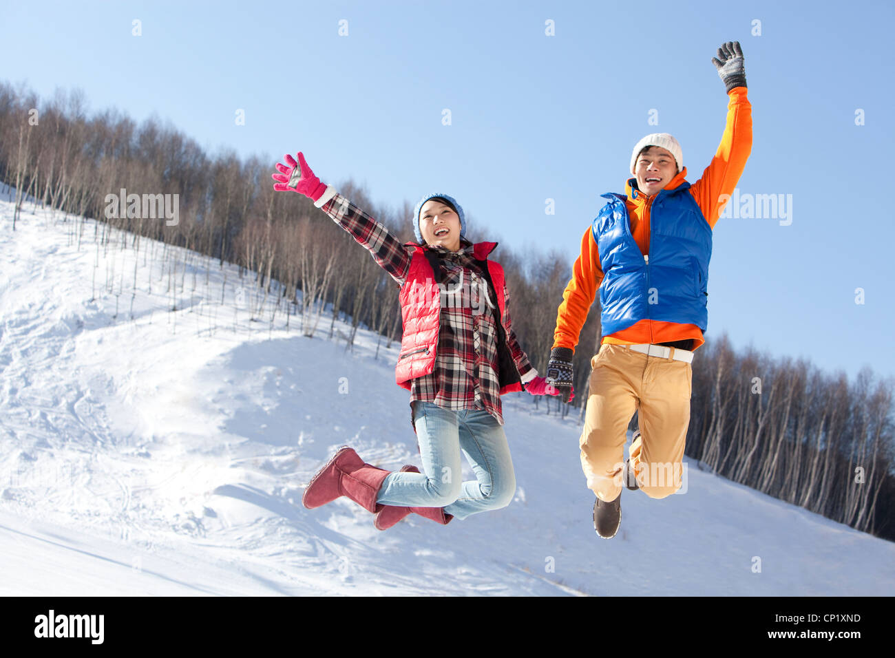 Young couple having fun in snow Stock Photo - Alamy
