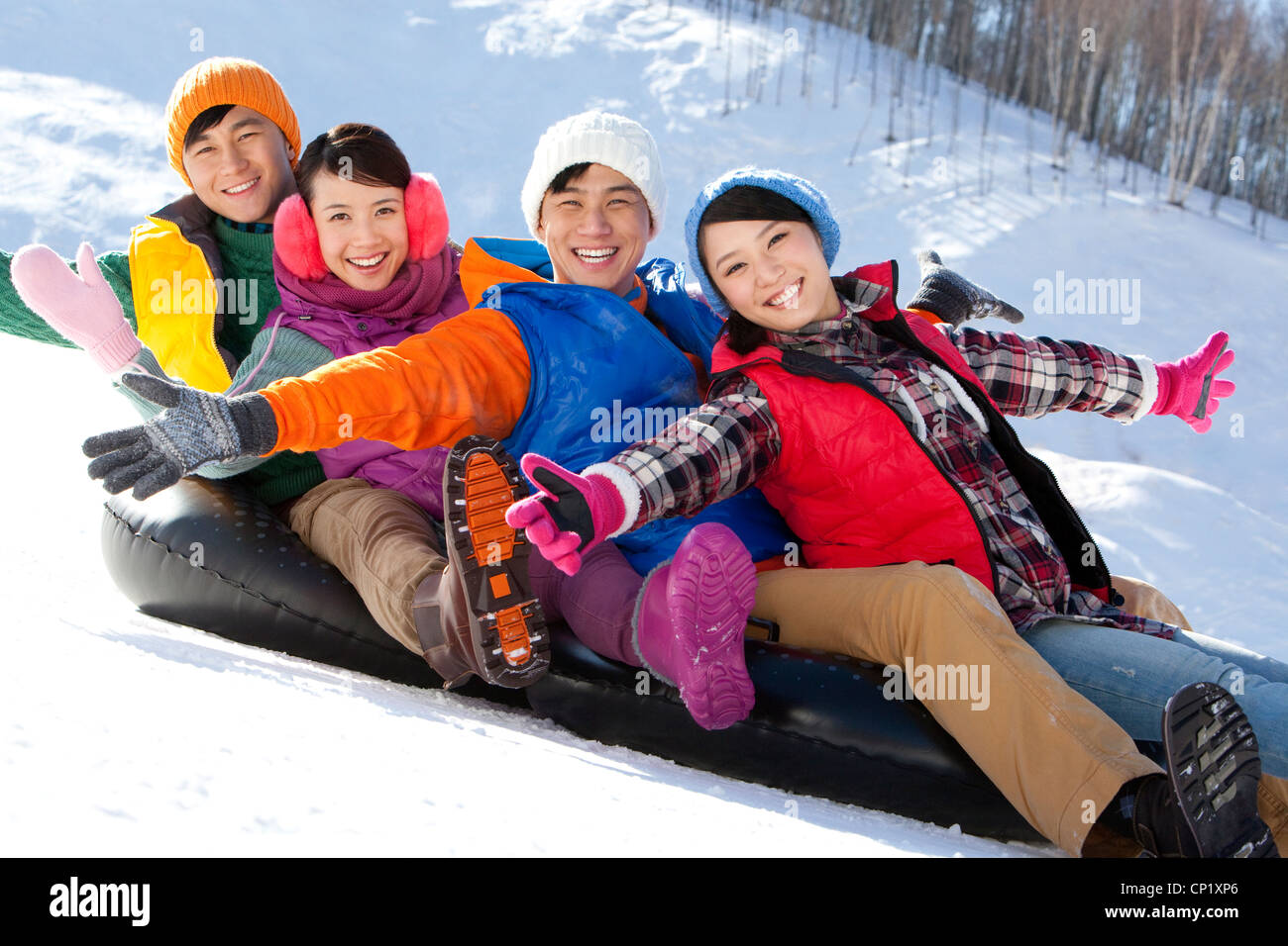 Young people having fun in snow Stock Photo - Alamy