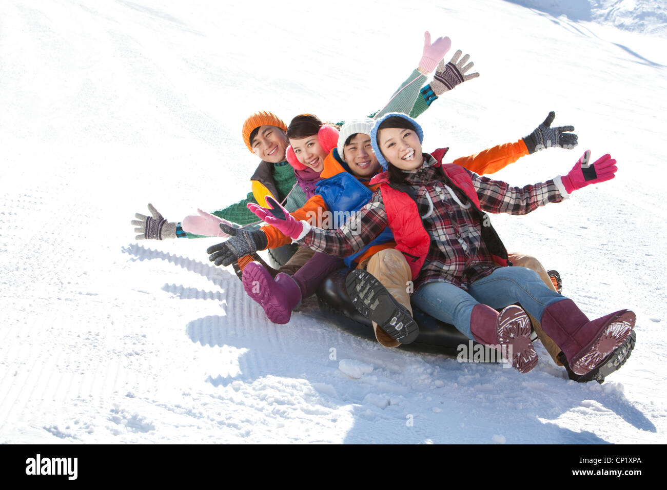 Young people having fun in snow Stock Photo - Alamy