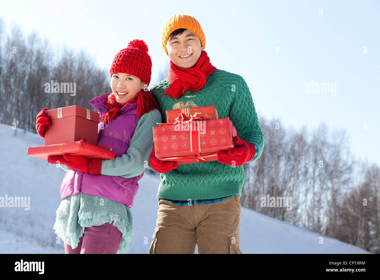 Young people holding gift boxes Stock Photo - Alamy