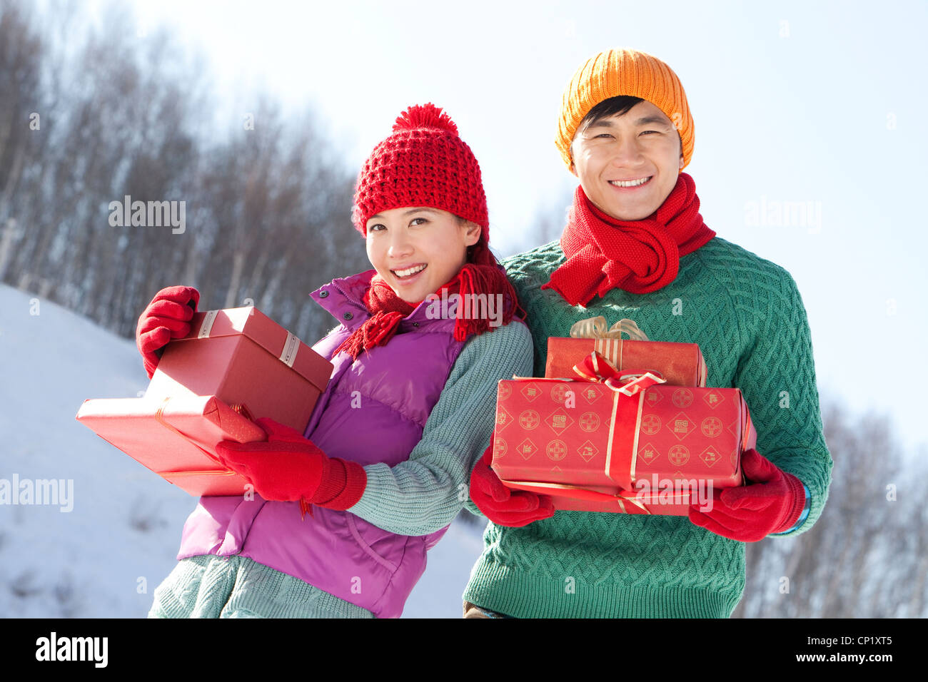 Young people holding gift boxes Stock Photo - Alamy