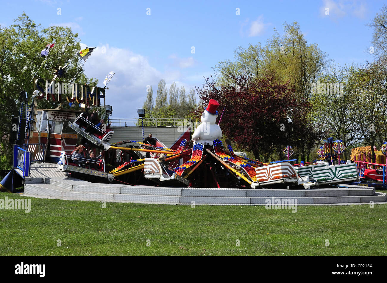 Adults and children on 'Ski Jump' fairground ride having fun Stock ...