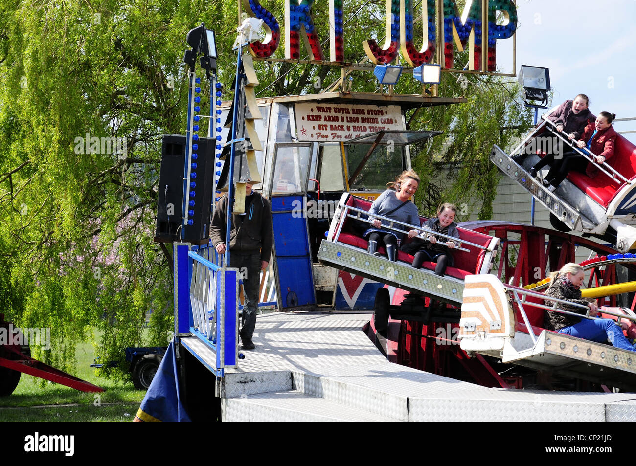 Adults and children on 'Ski Jump' fairground ride having fun Stock ...