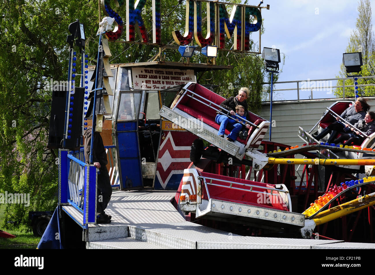 Adults and children on 'Ski Jump' fairground ride having fun Stock ...