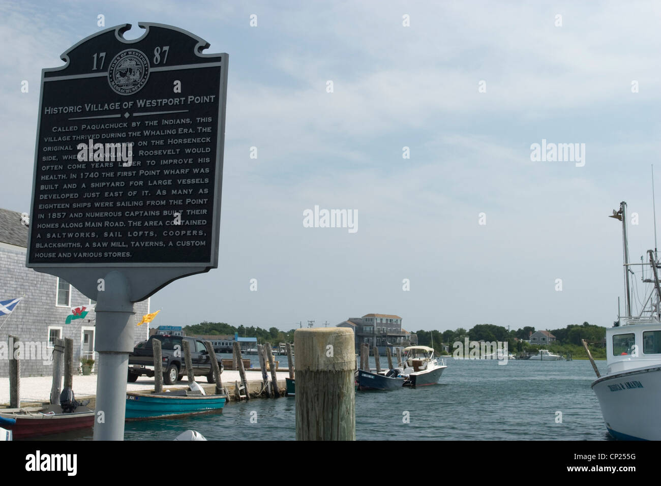A metal sign announces the port of Westport, a harbor view on southern ...