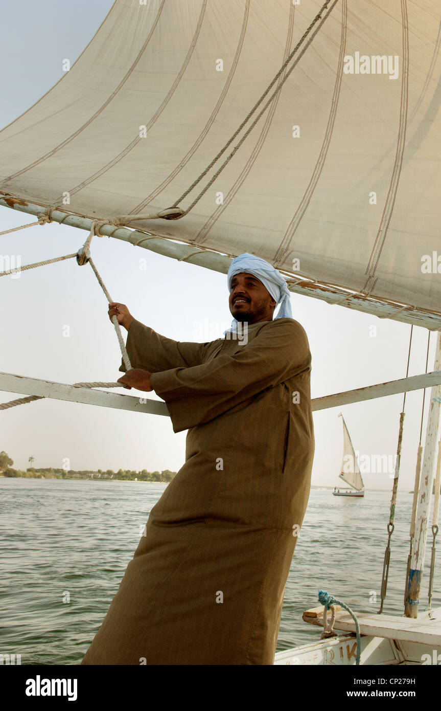 An Egyptian sailor sailing his Felucca on the River Nile in Luxor Stock ...