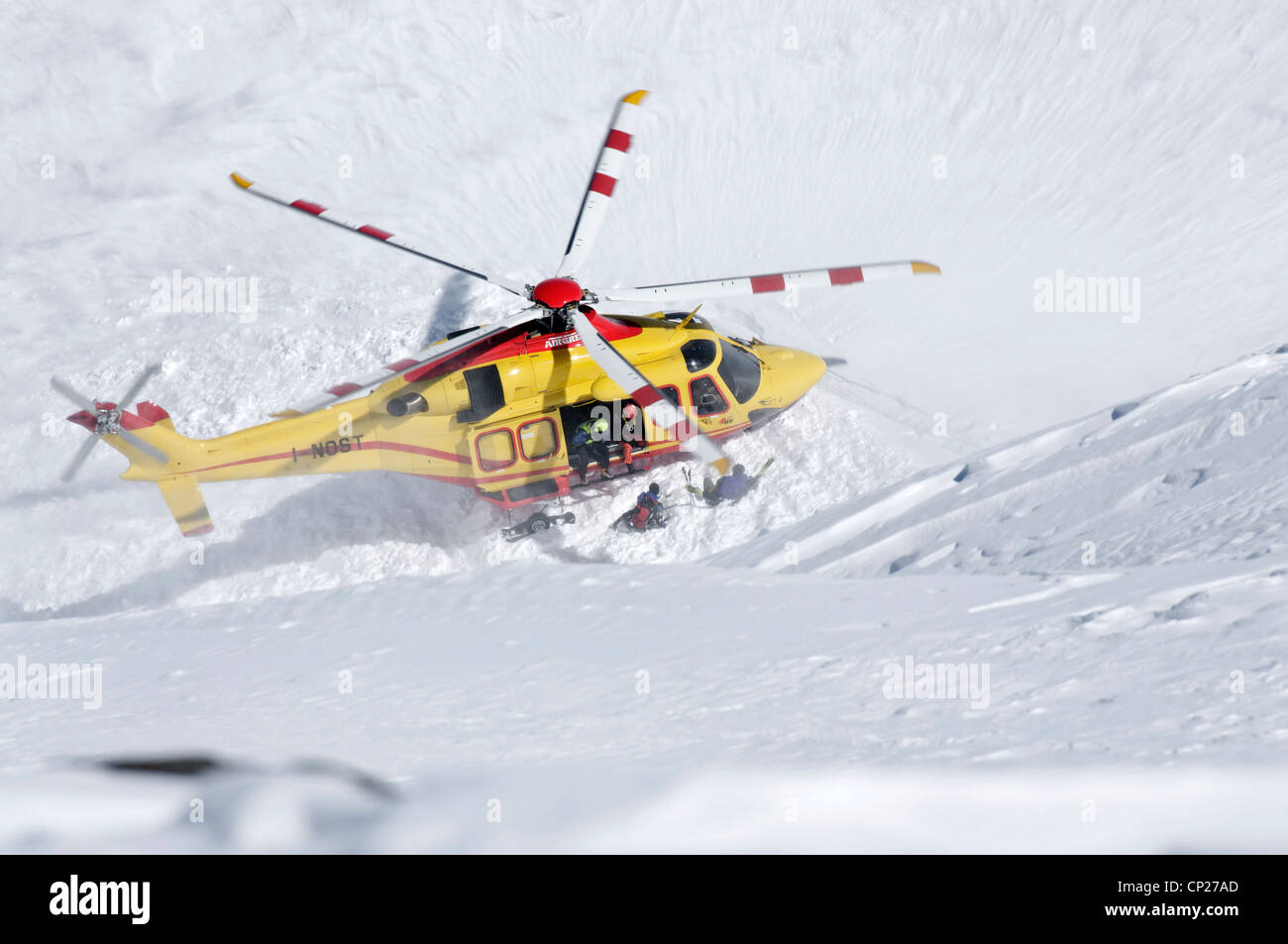 A rescue helicopter approaching an avalanche scene Stock Photo - Alamy