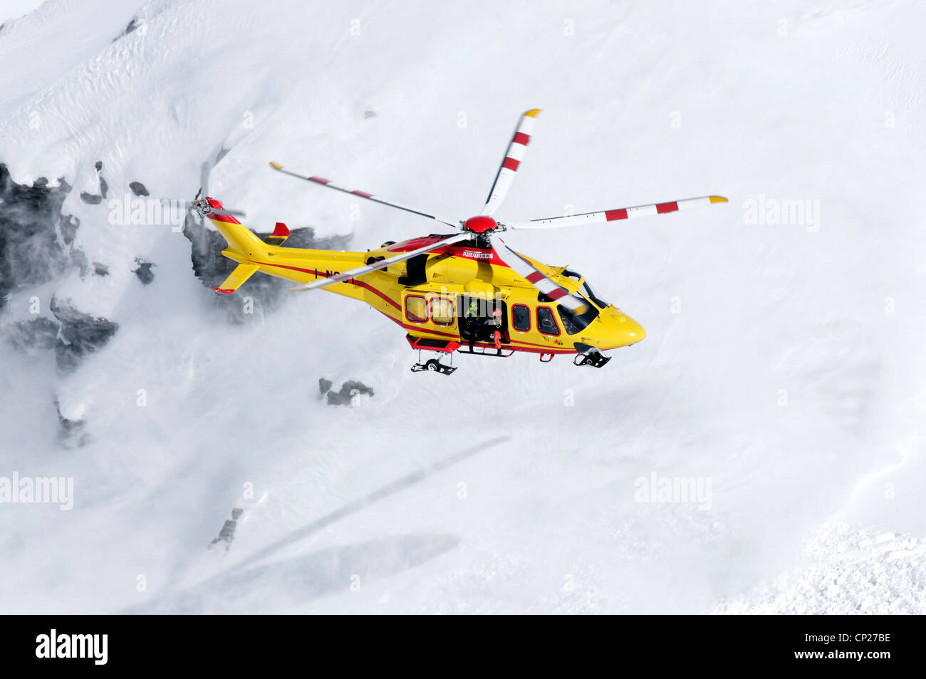 A rescue helicopter approaching an avalanche scene Stock Photo - Alamy