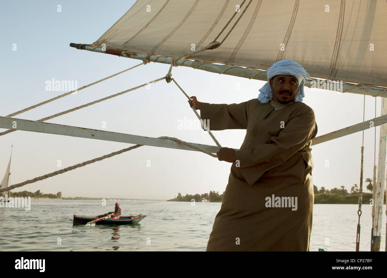 An Egyptian sailor sailing his Felucca on the River Nile in Luxor Stock ...