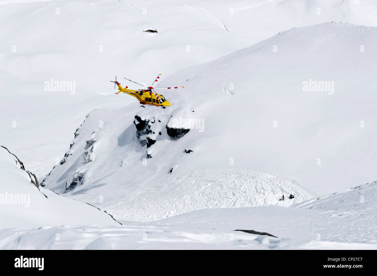 A rescue helicopter approaching an avalanche scene Stock Photo - Alamy